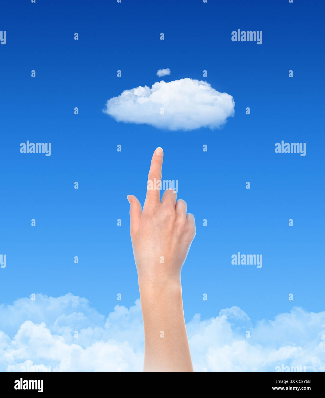 Woman hand touch the cloud against blue sky with clouds. Concept image ...