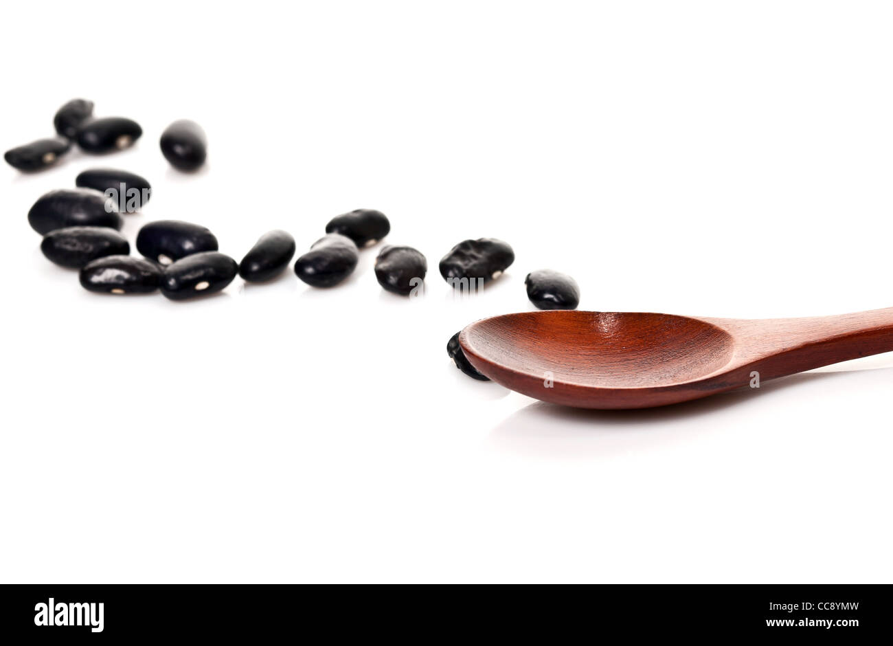 Black beans wooden spoon Cut Out Stock Images & Pictures - Alamy