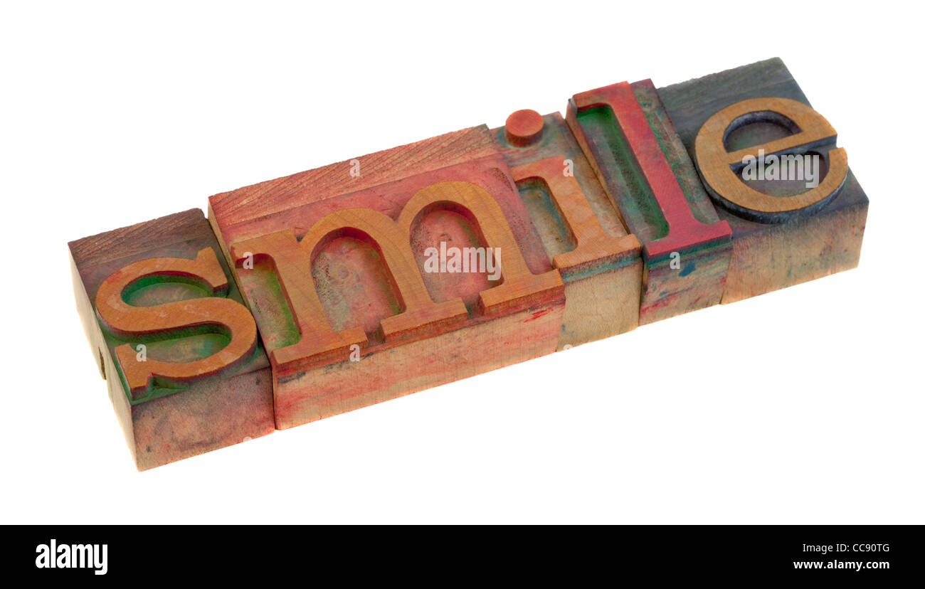 the smile word in vintage wooden letterpress type blocks, stained by ...