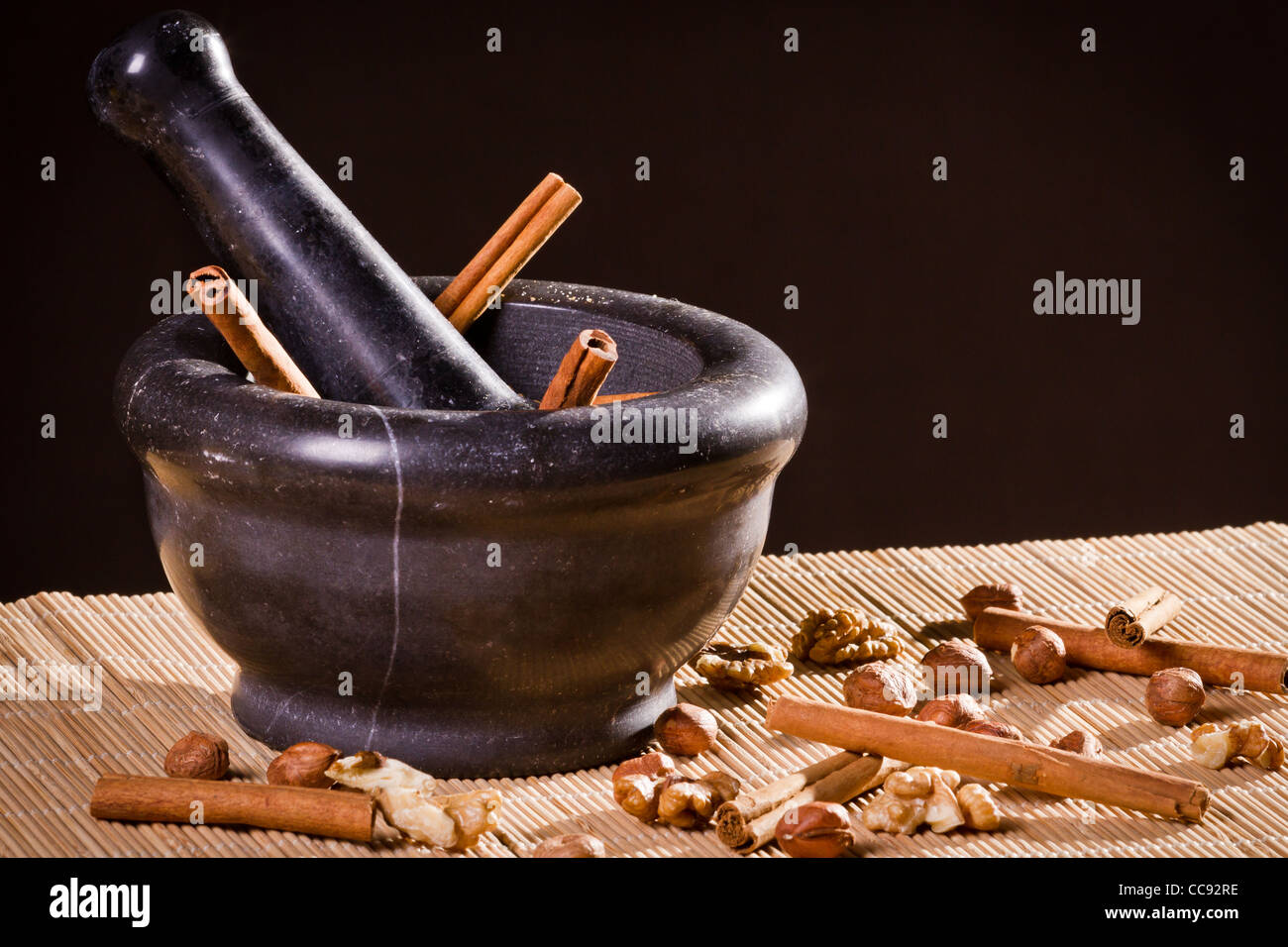 Different kinds of nuts in dark mortar Stock Photo - Alamy