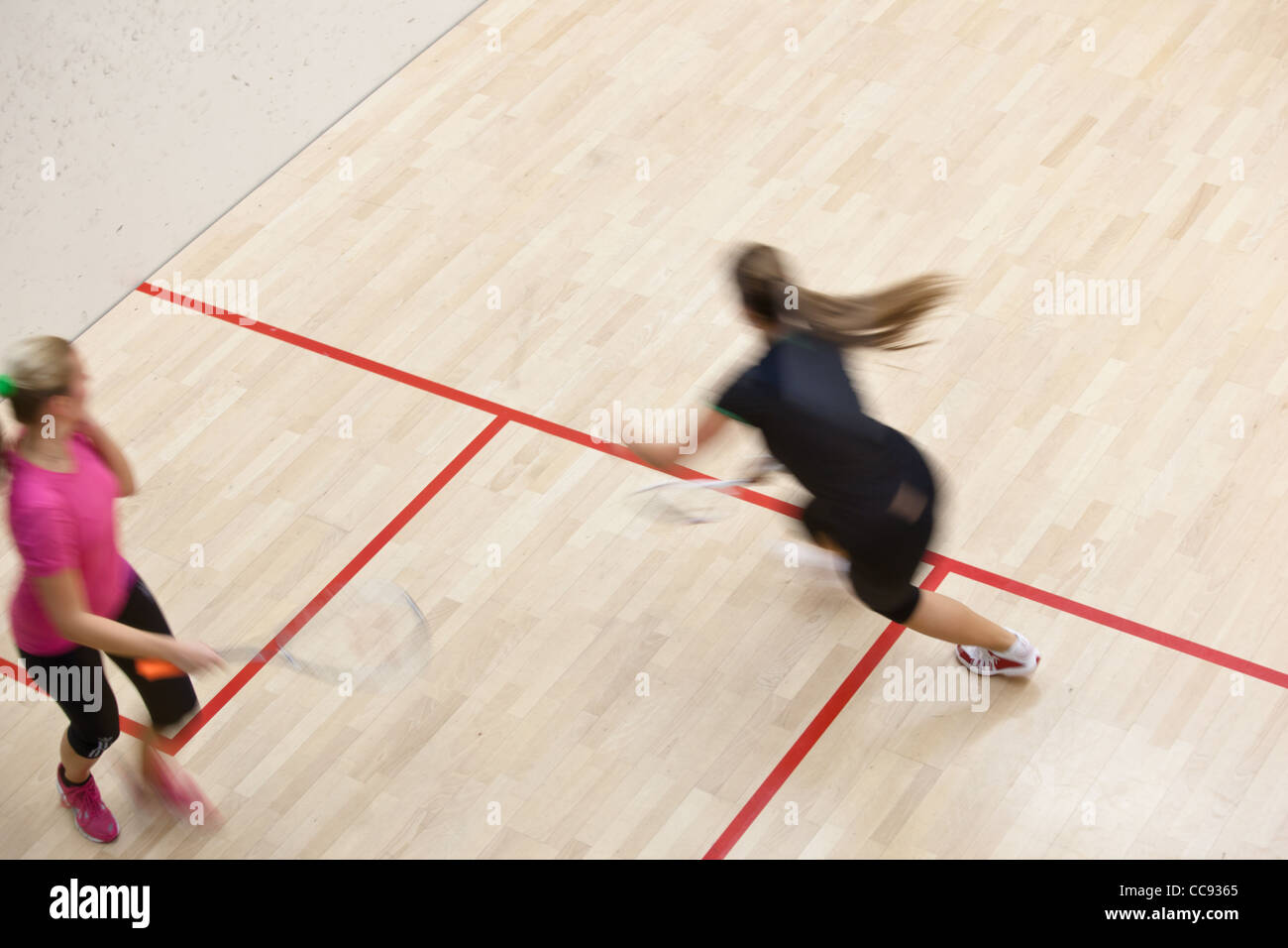 Two female squash players on a squash court Stock Photo - Alamy