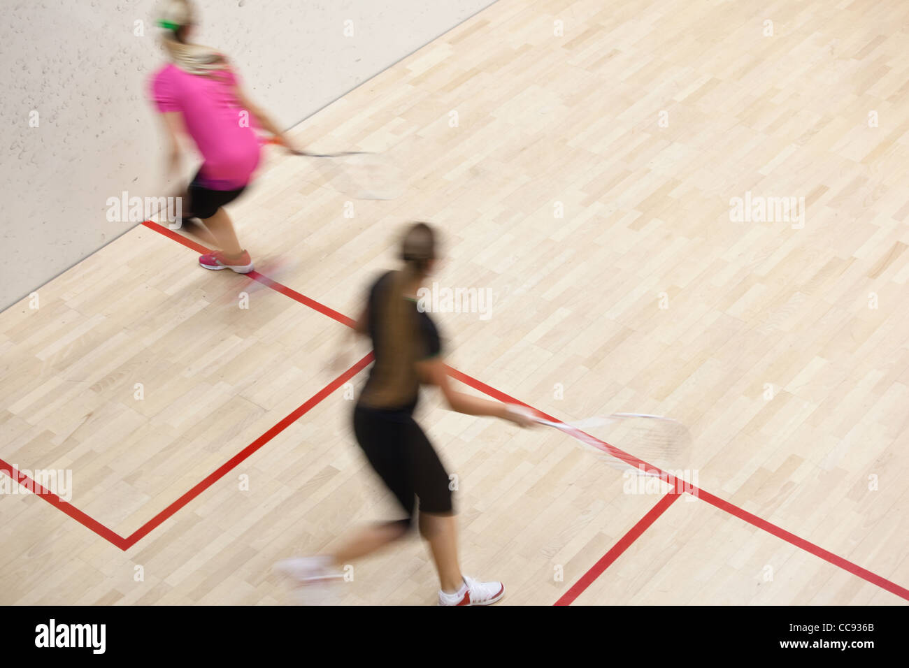 Two female squash players on a squash court Stock Photo - Alamy