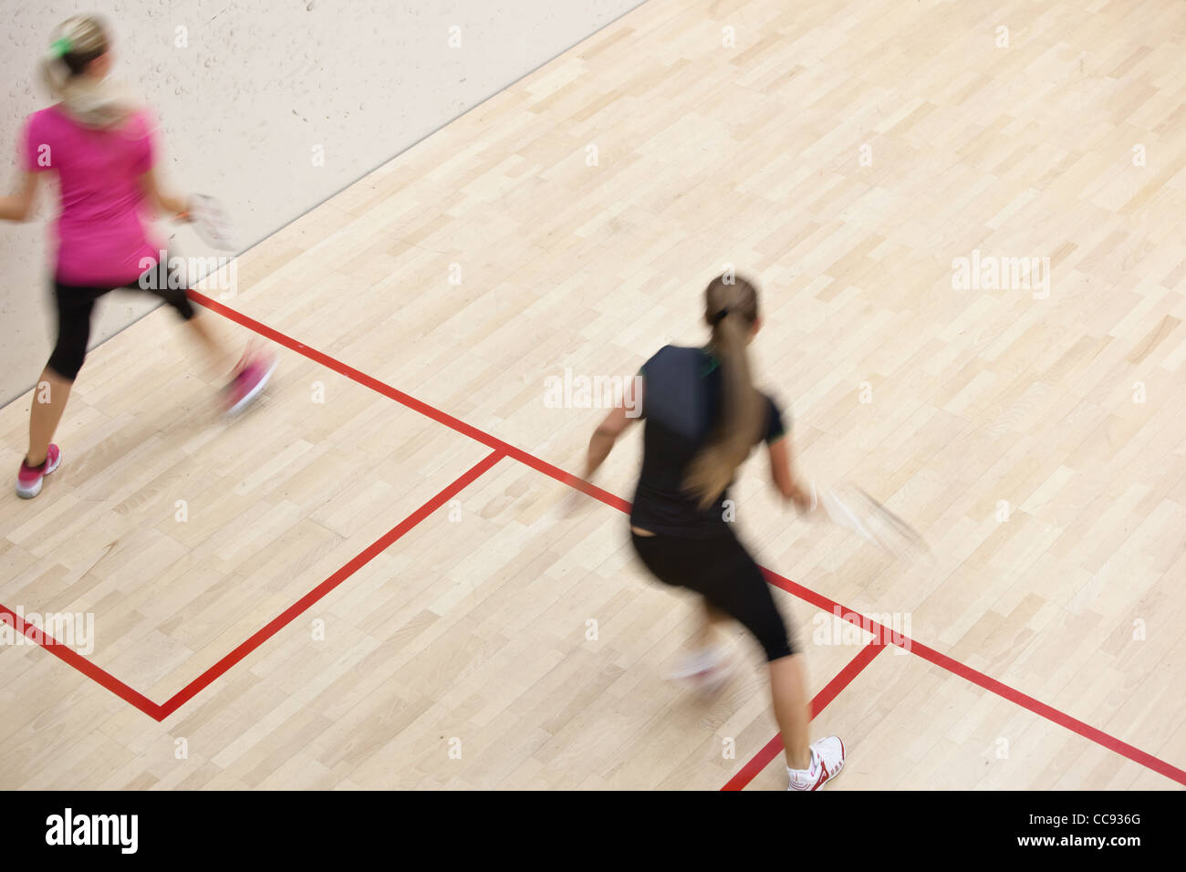 Two female squash players on a squash court Stock Photo - Alamy