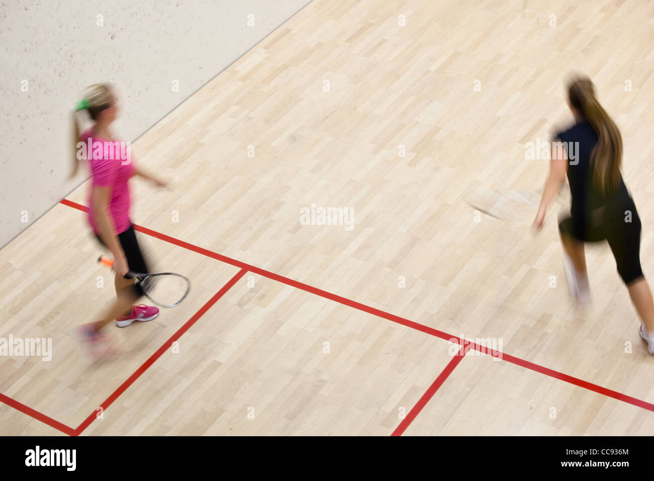 Two female squash players on a squash court Stock Photo - Alamy