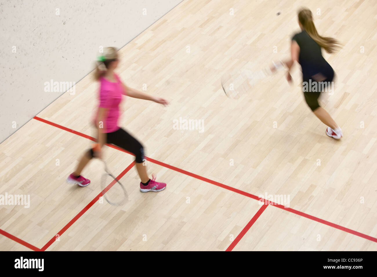 Two female squash players on a squash court Stock Photo - Alamy