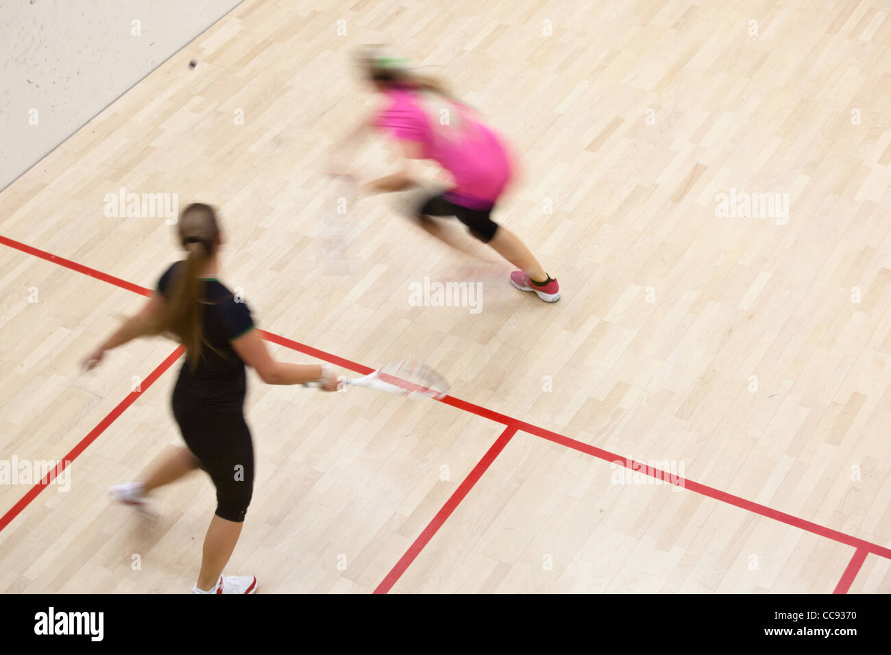 Two female squash players on a squash court Stock Photo - Alamy