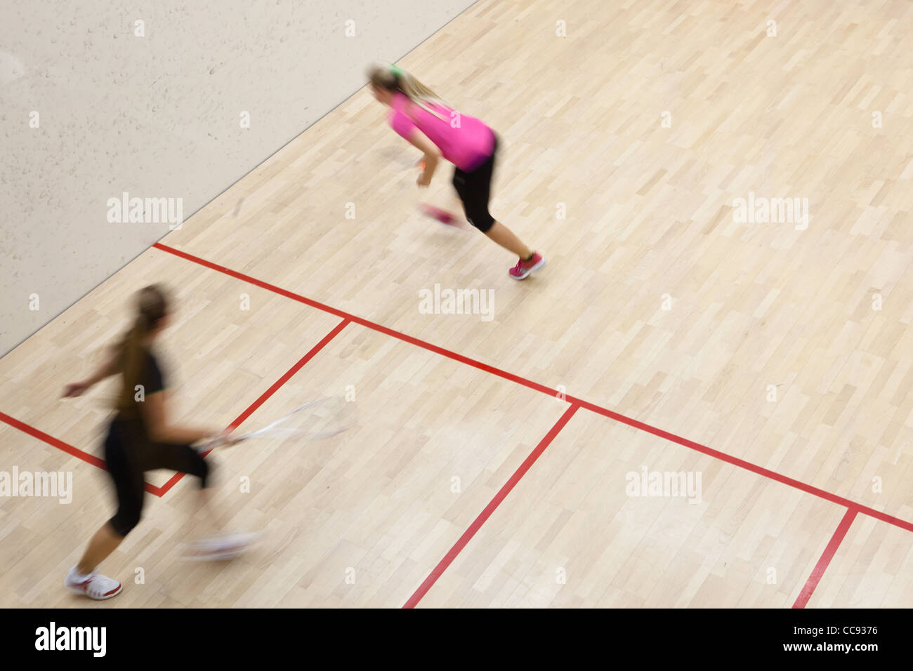Two female squash players on a squash court Stock Photo - Alamy
