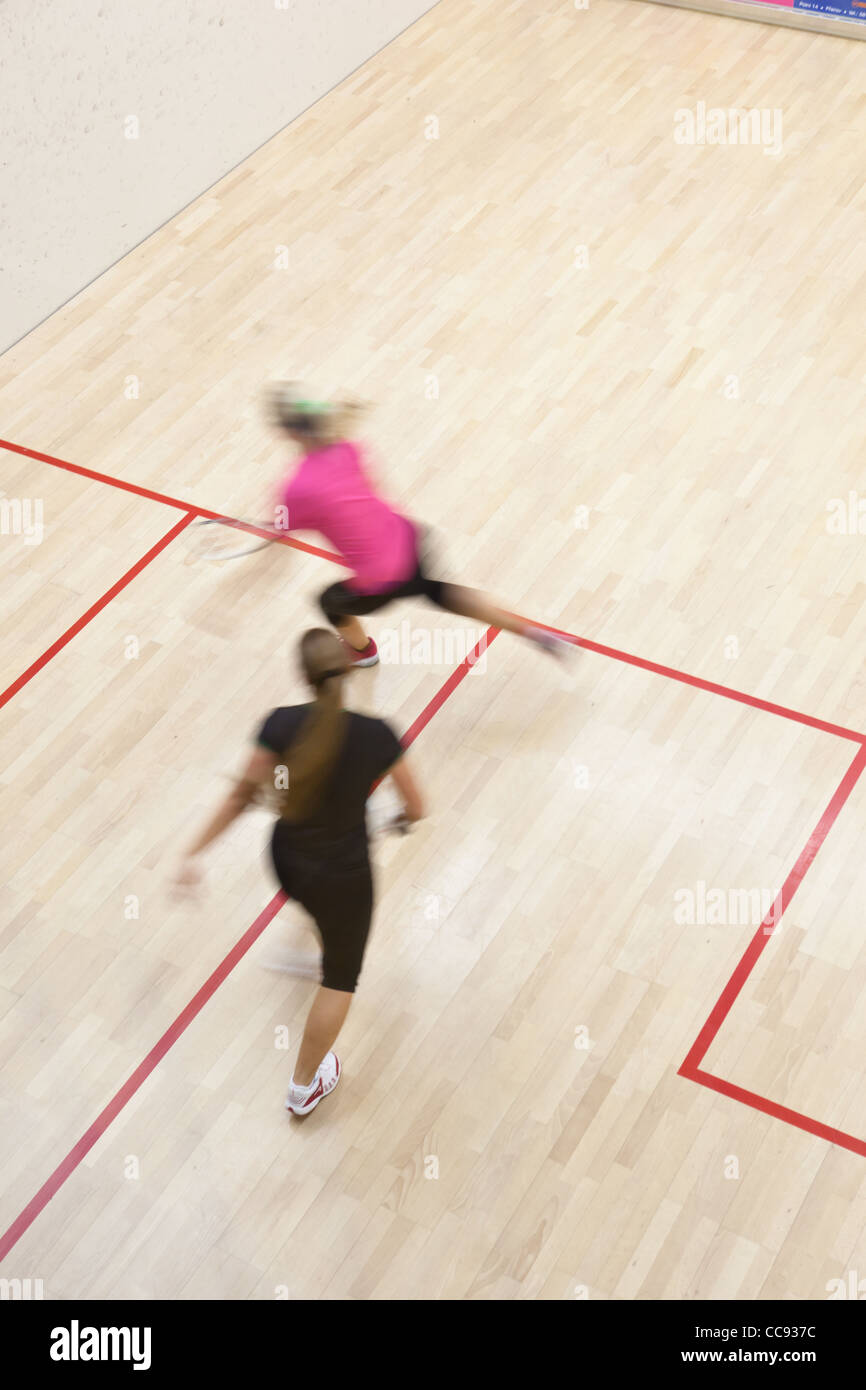 Two female squash players on a squash court Stock Photo - Alamy