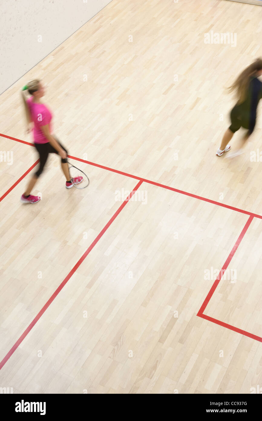 Two female squash players on a squash court Stock Photo - Alamy