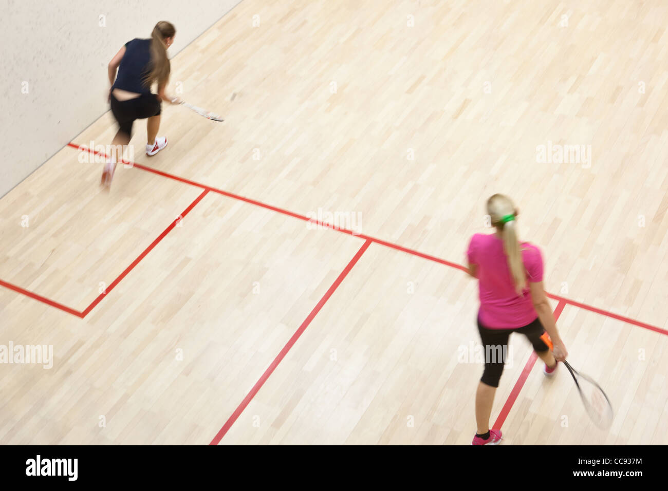 Two female squash players on a squash court Stock Photo - Alamy