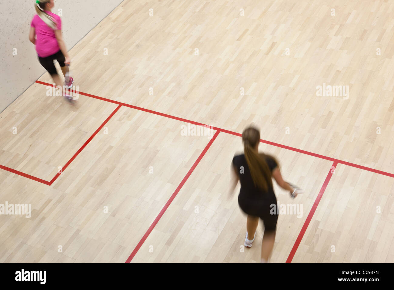Two female squash players on a squash court Stock Photo - Alamy