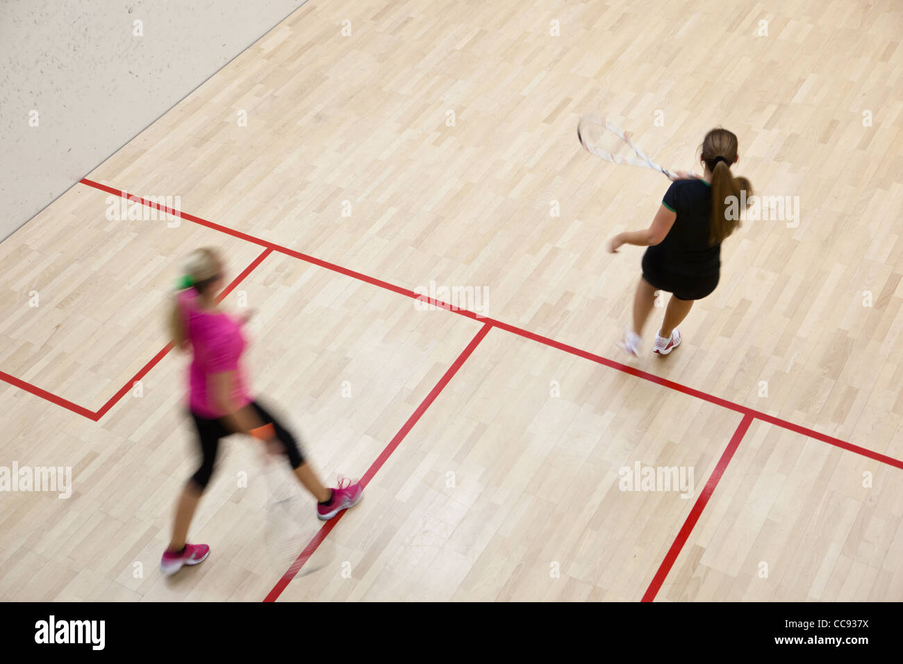 Two female squash players on a squash court Stock Photo - Alamy
