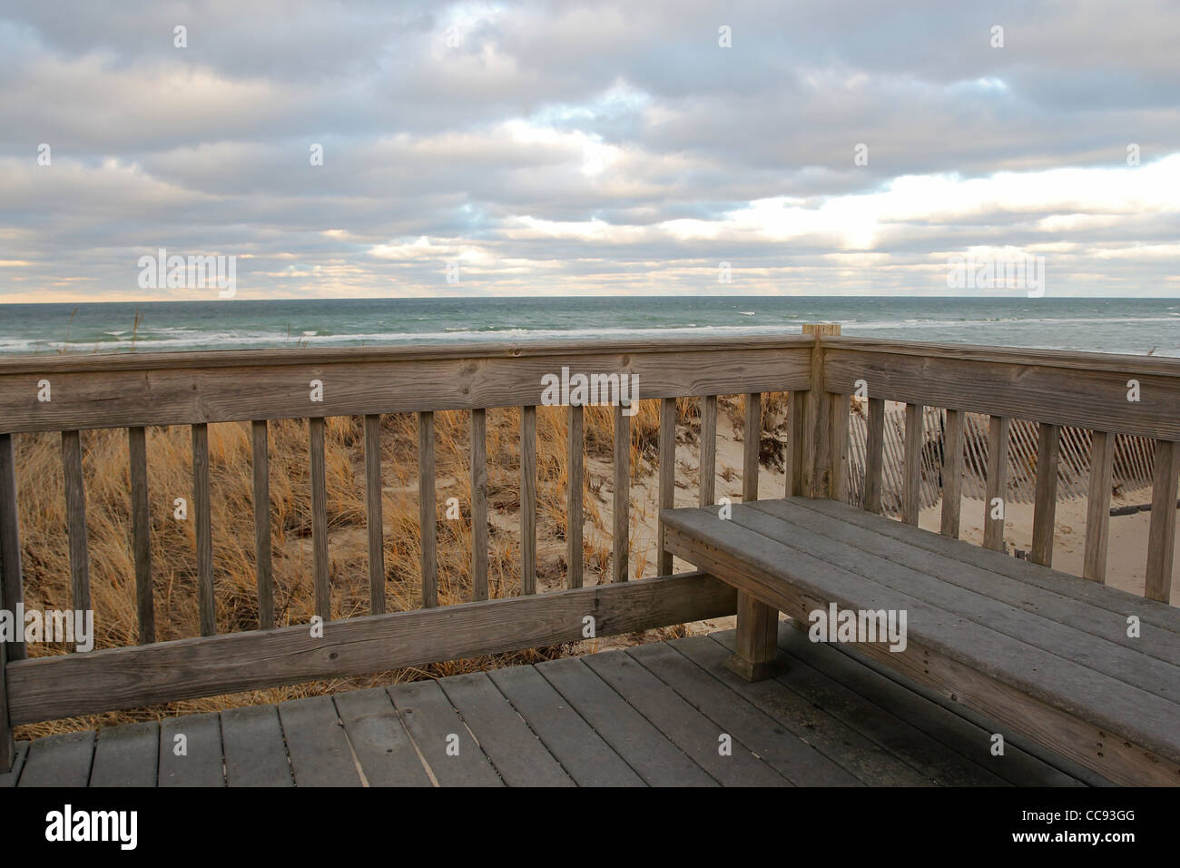 A bench and deck overlooking Sandy Neck Beach in winter, Sandwich, Cape ...