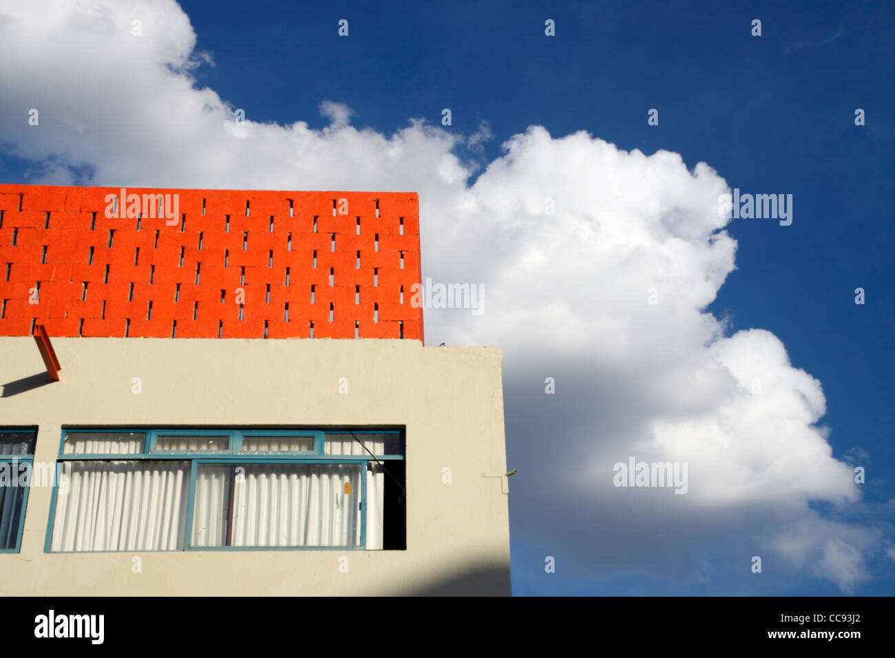 Typical Mexican house colours contrasting on blue sky with cloud white ...