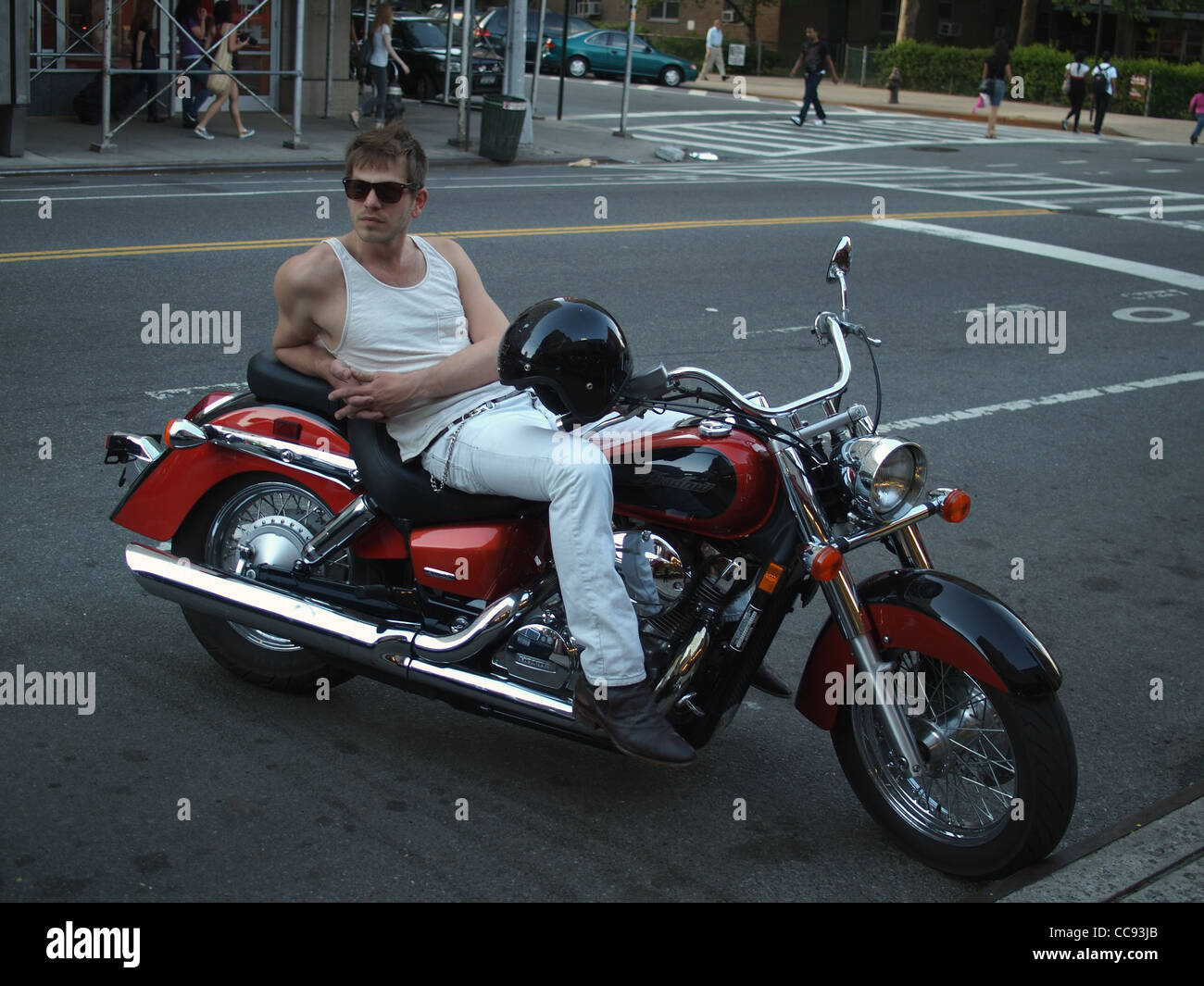 Man reclining on motorcycle, Second Avenue, New York City Stock Photo ...