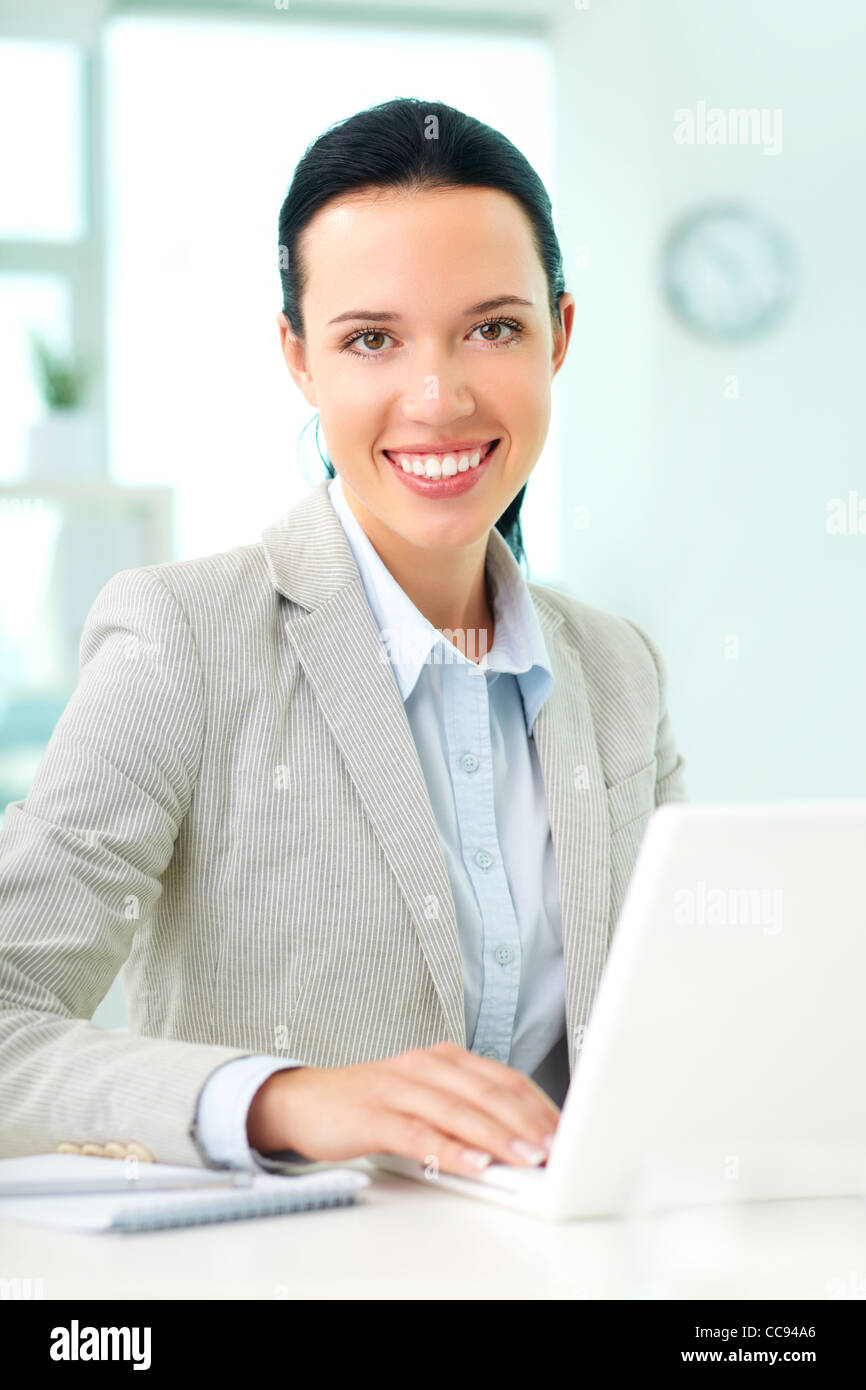 Portrait of pretty secretary looking at camera while working Stock ...