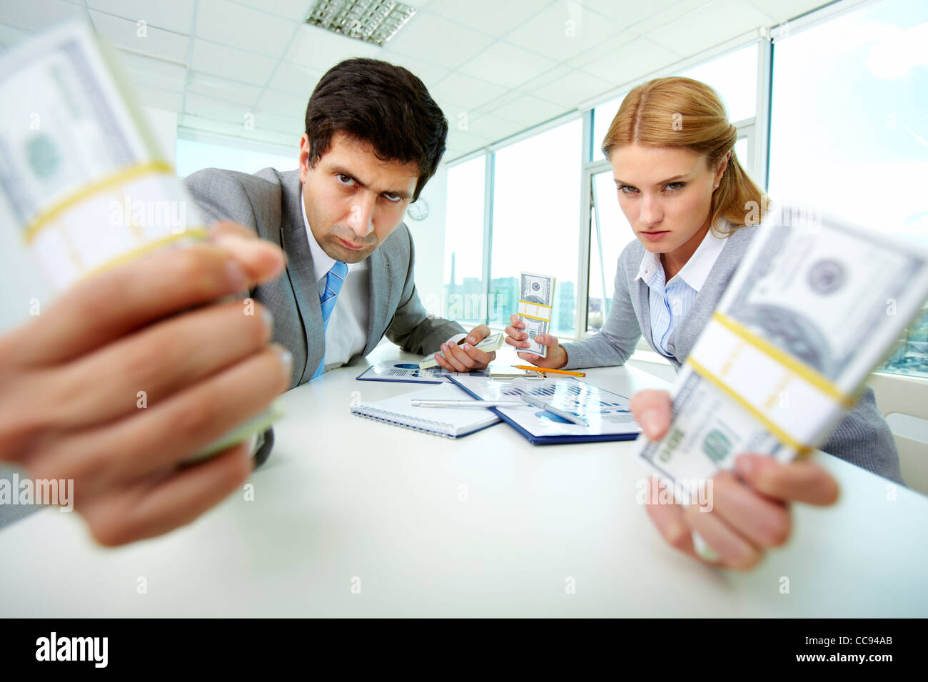 Image of angry employees with dollar bills in hands looking at you with ...