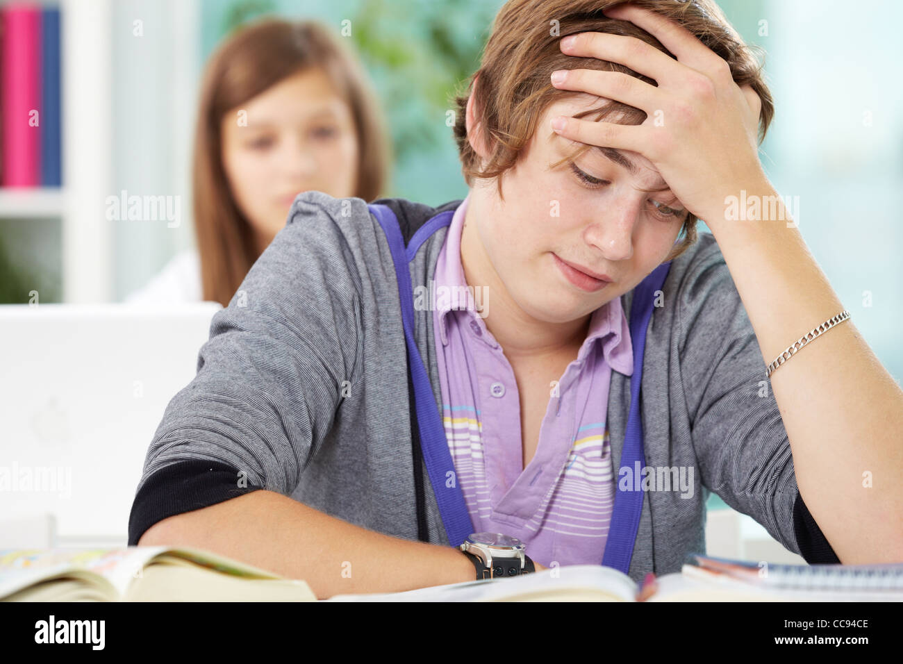 Portrait of teenage lad reading book during lesson Stock Photo - Alamy