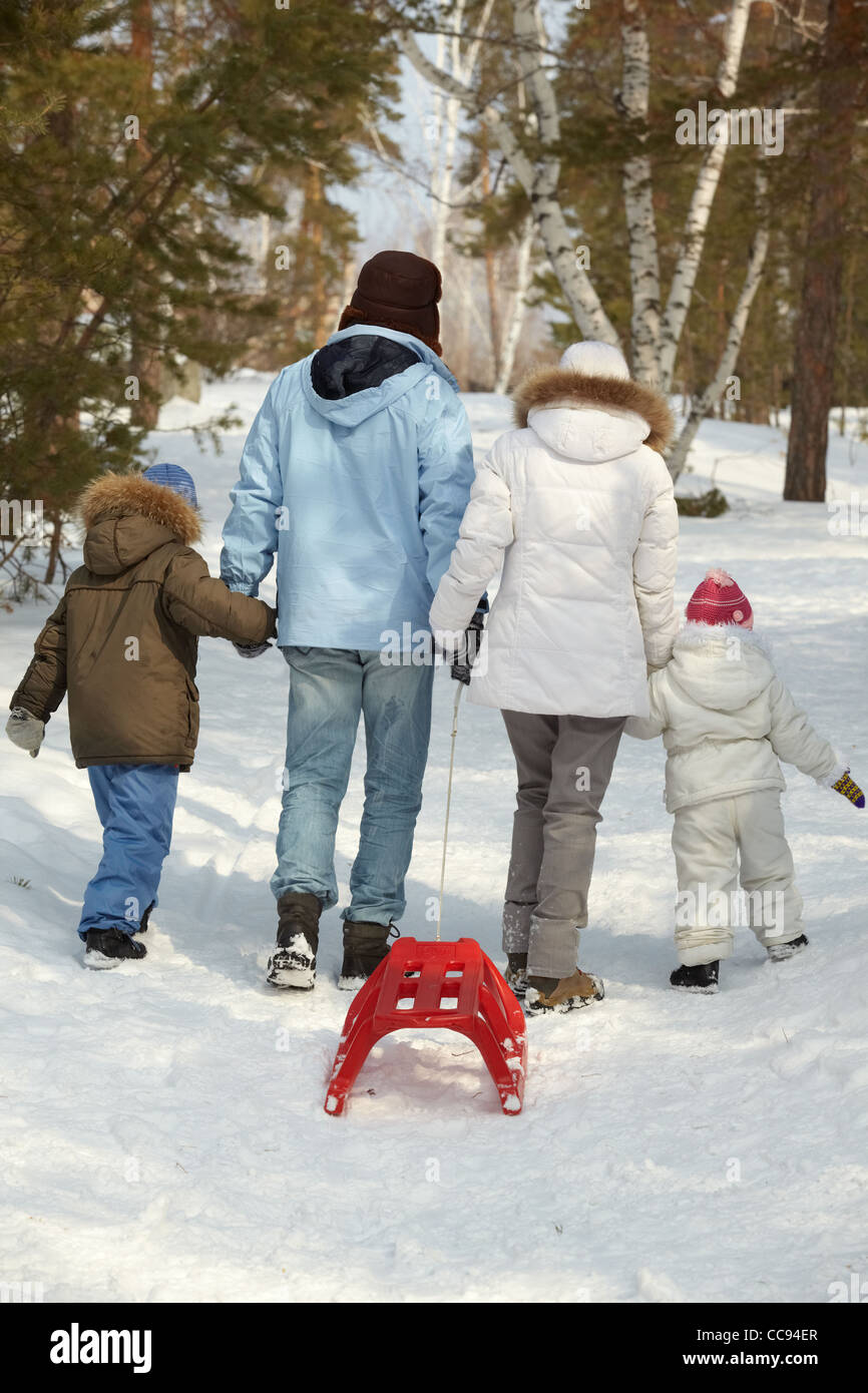 Rear view of kids and their parents walking in park Stock Photo - Alamy