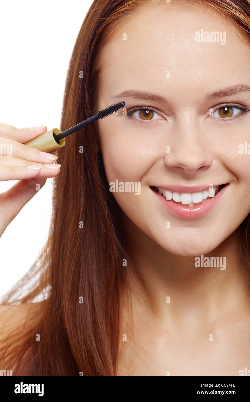 Fresh girl with mascara looking at camera over white background Stock ...