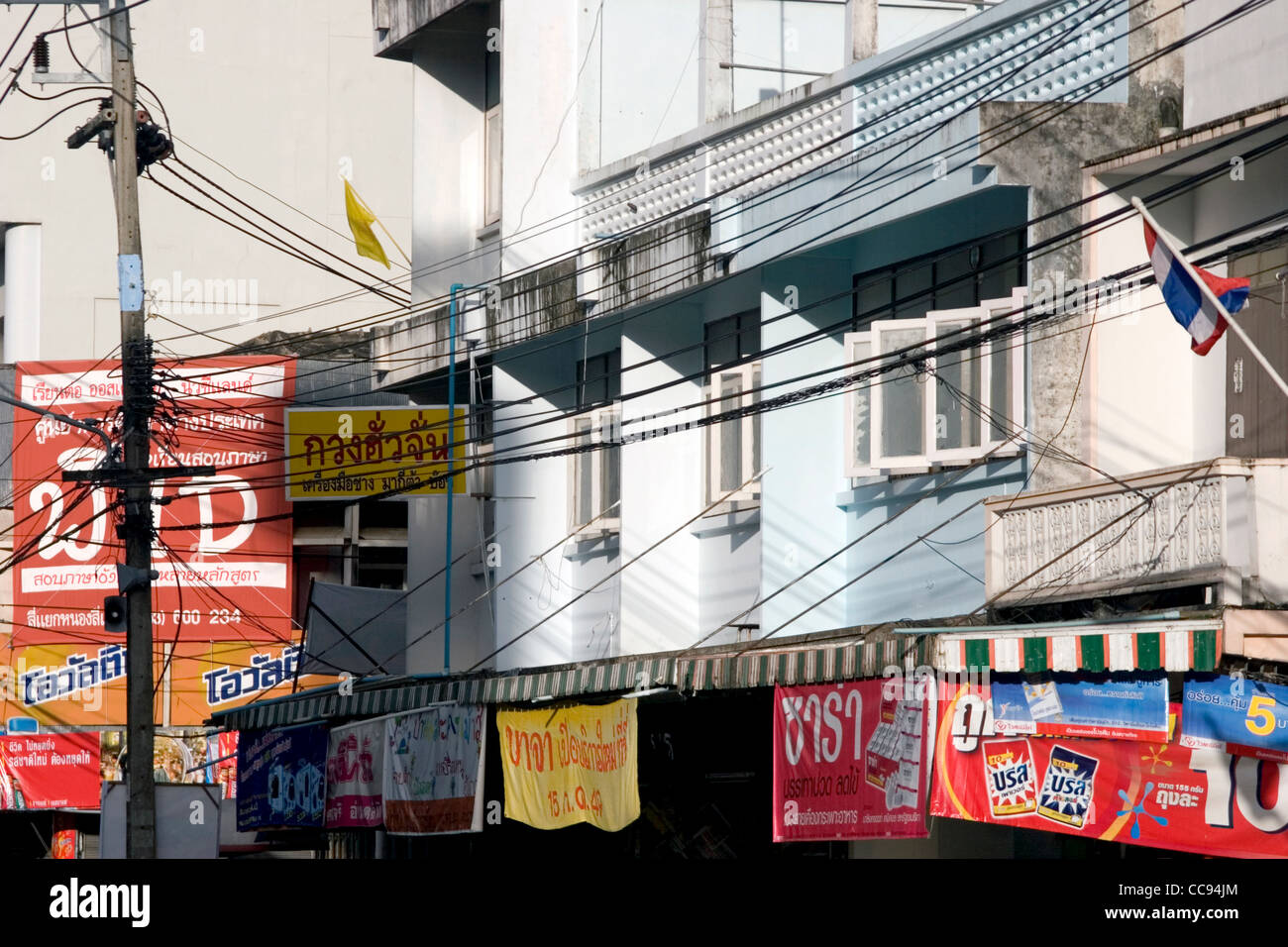 Many signs and banners written in Thai are part of the urban landscape ...