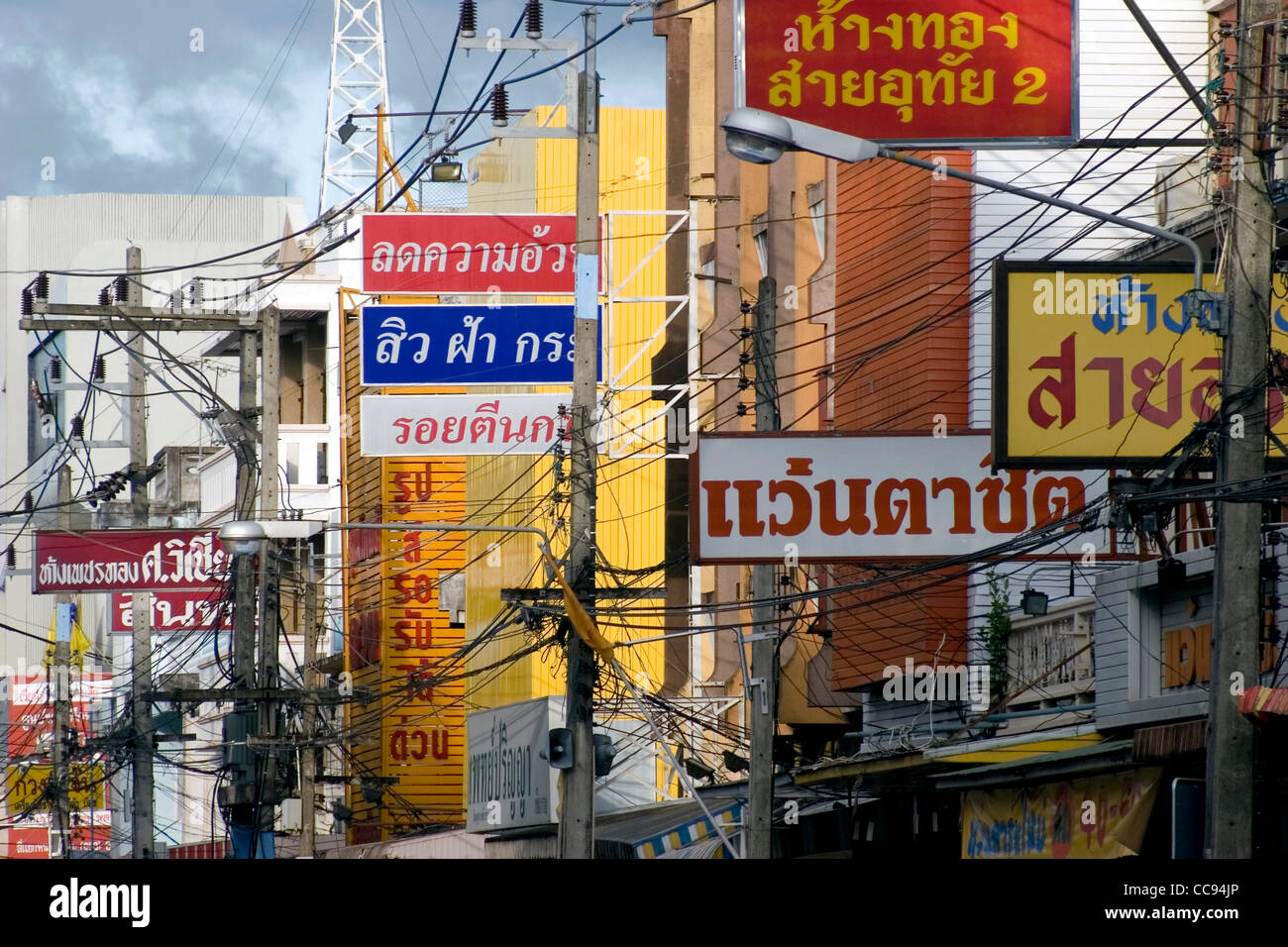 Many signs written in Thai are part of the urban landscape on a city ...