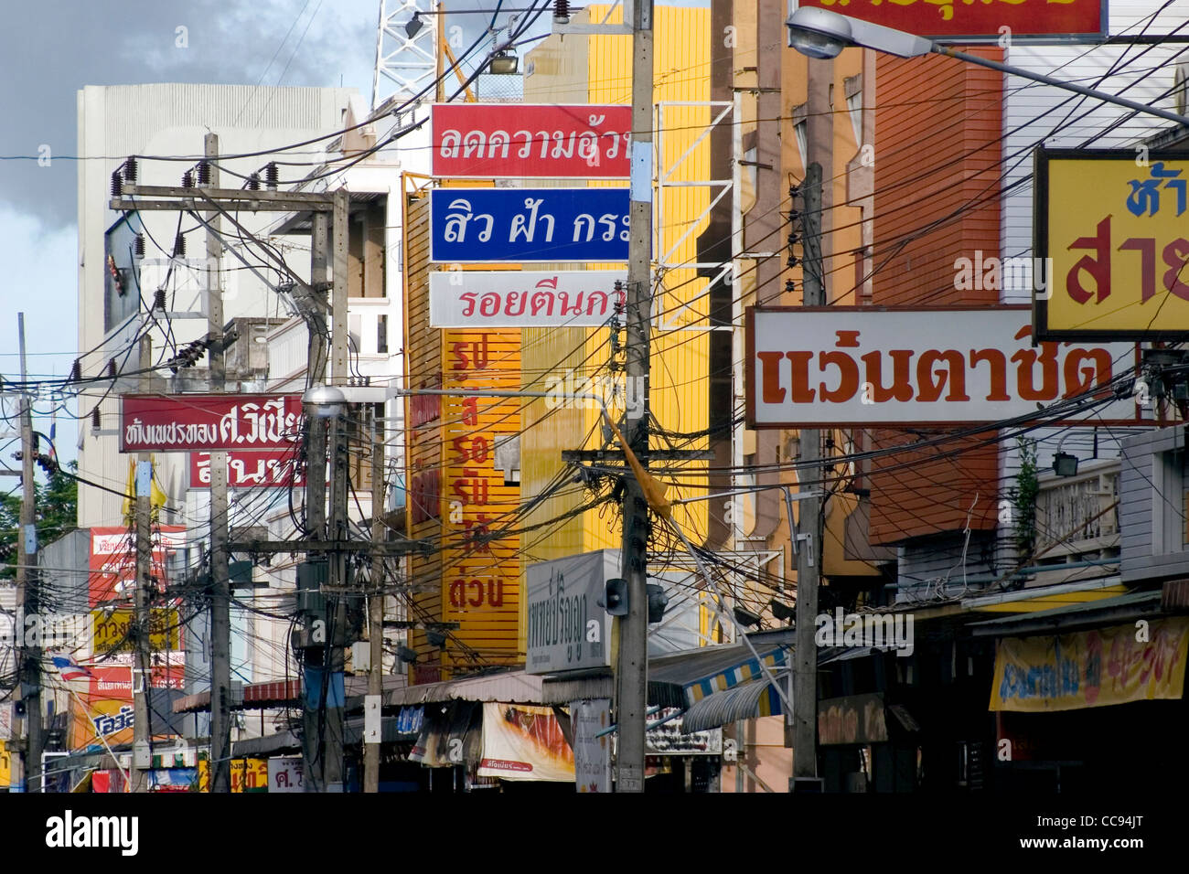 Many signs written in Thai are part of the urban landscape on a city ...