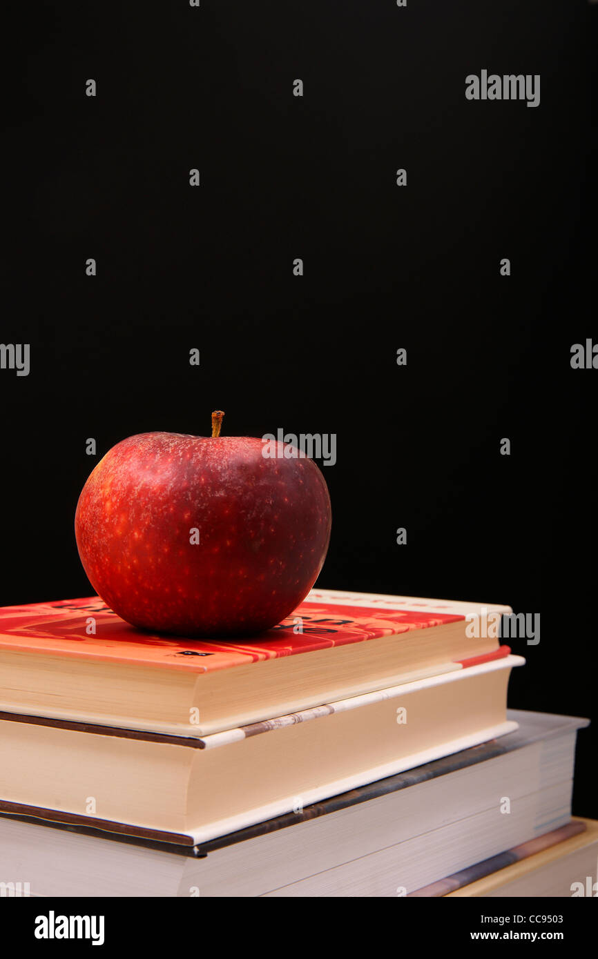 Apple on books Stock Photo - Alamy