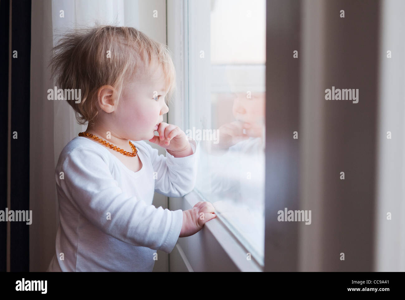 Portrait of Baby Girl Looking out Window Stock Photo - Alamy