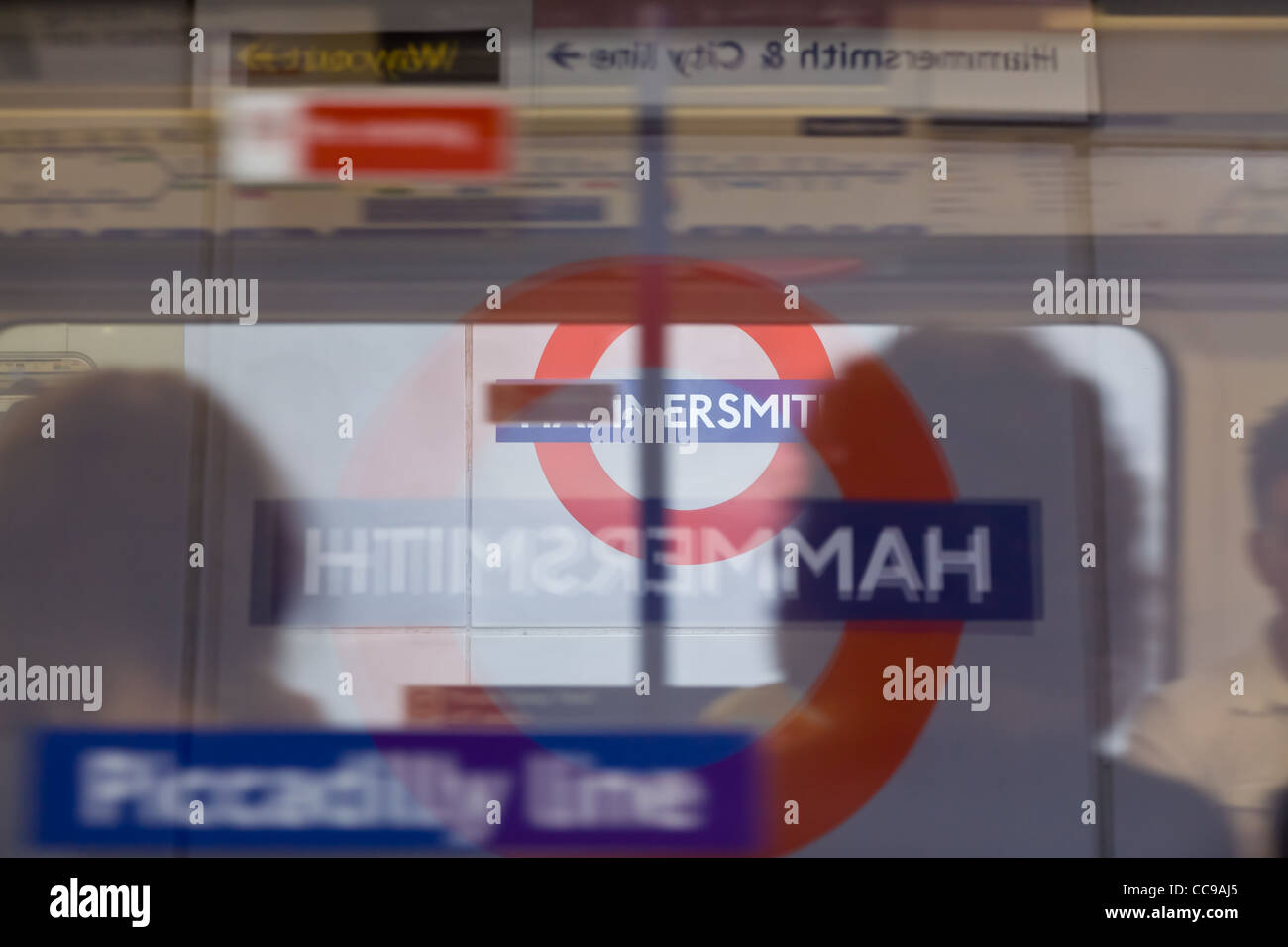 Hammersmith tube station sign seen through a window of moving carriage ...