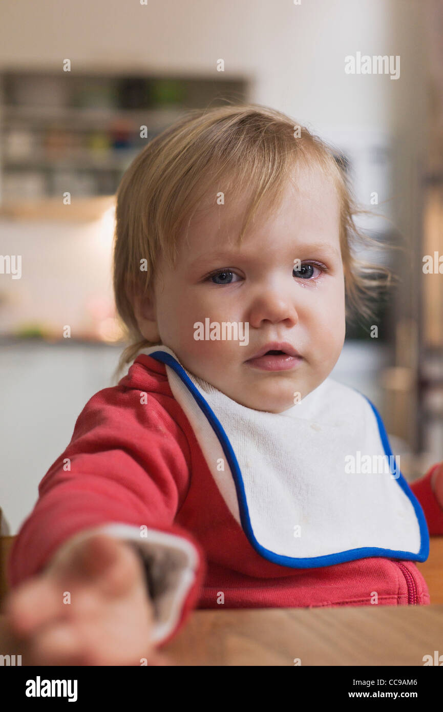 Portrait of Sad Baby Girl Sitting in High Chair Stock Photo - Alamy
