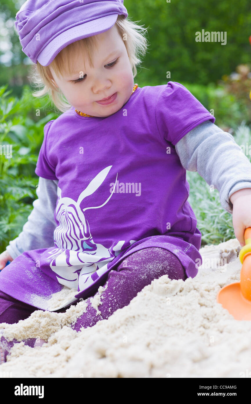 Girl Playing in Sand Stock Photo - Alamy