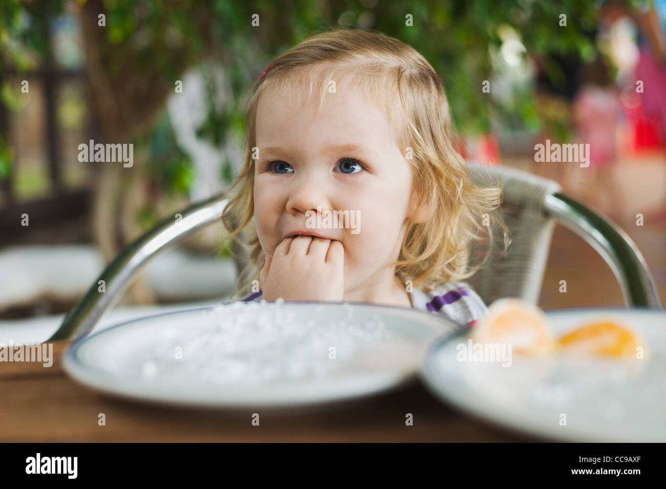 Girl Eating at Table Stock Photo - Alamy