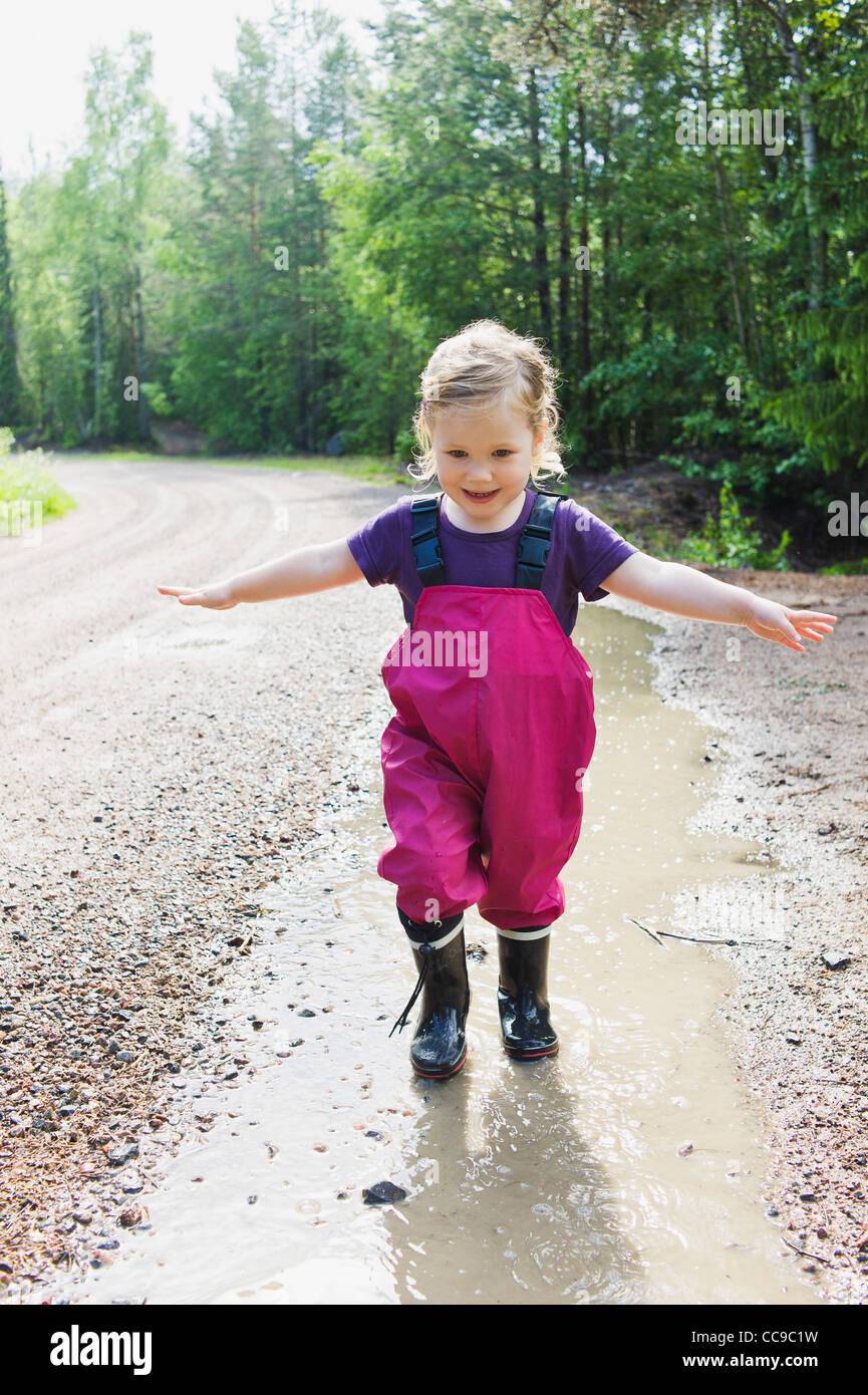 Young Girl Playing in Puddle, Sweden Stock Photo - Alamy