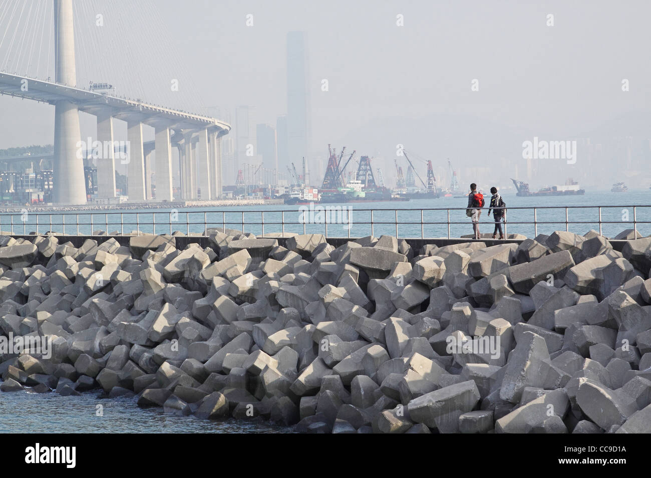 two people walking on breakwater Stock Photo - Alamy