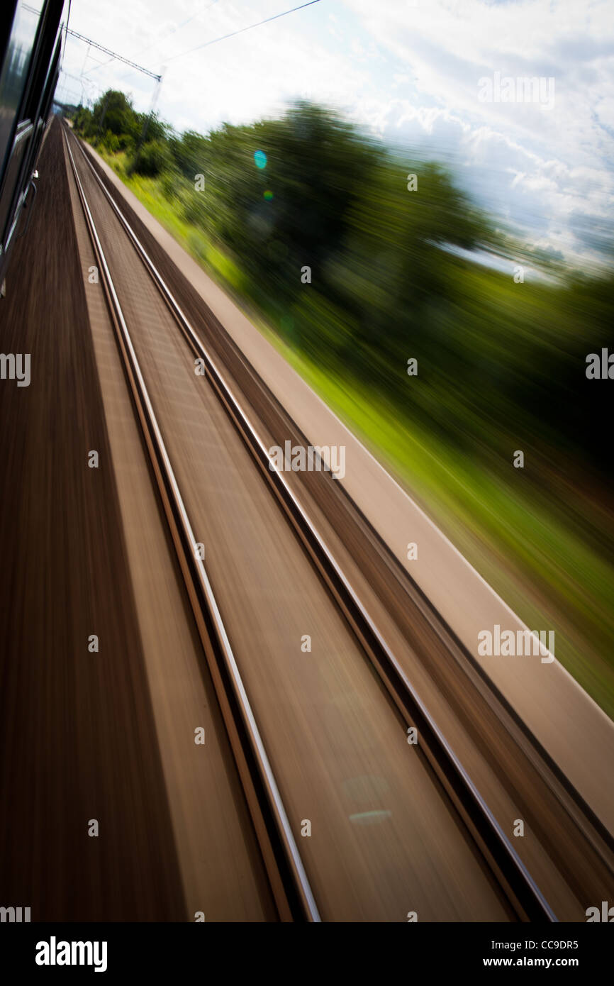 Railroad seen from a fast moving train. (motion blurred image; color ...