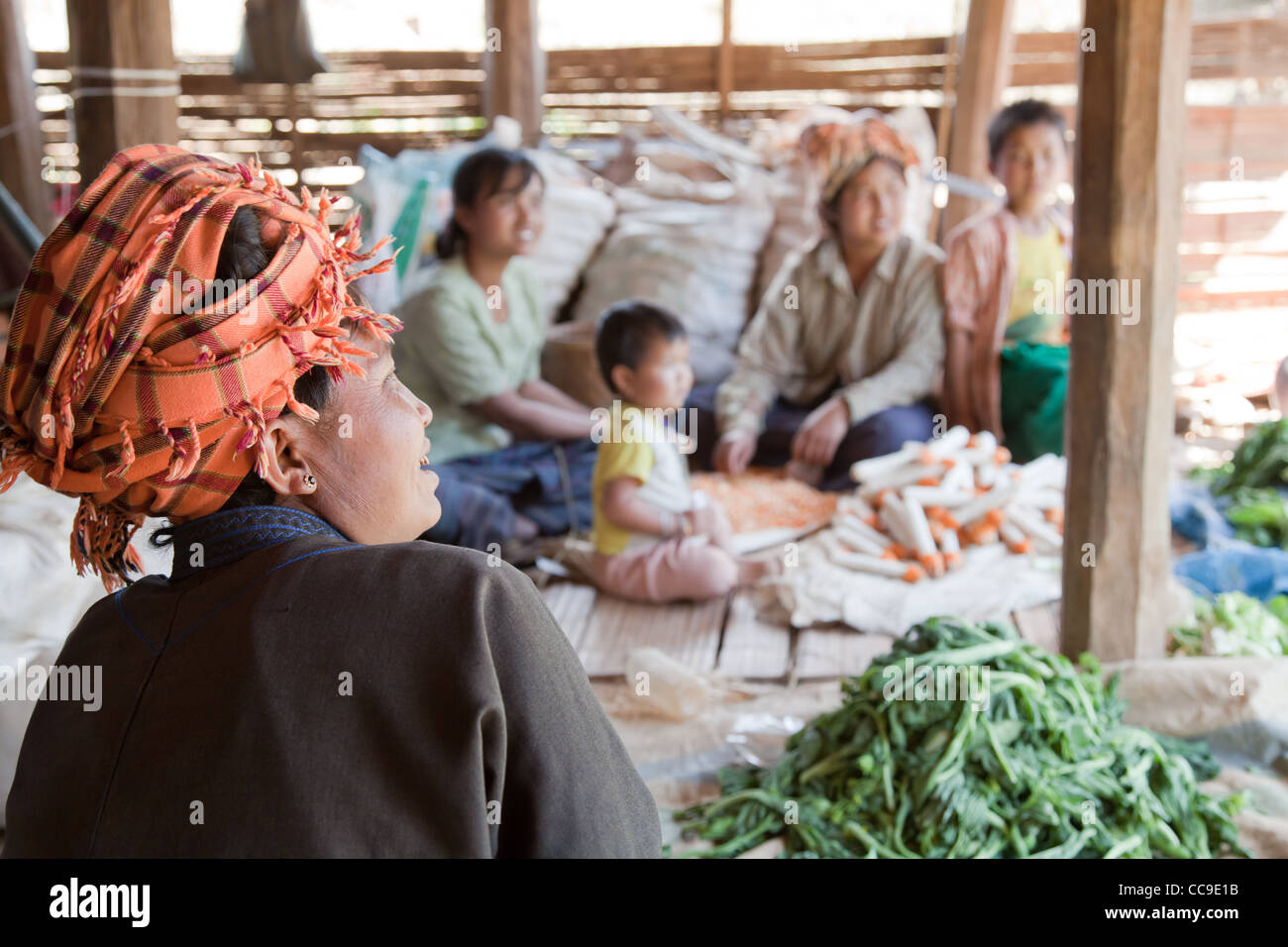 Pa-O tribal woman and kids in native costume are sitting around corn ...