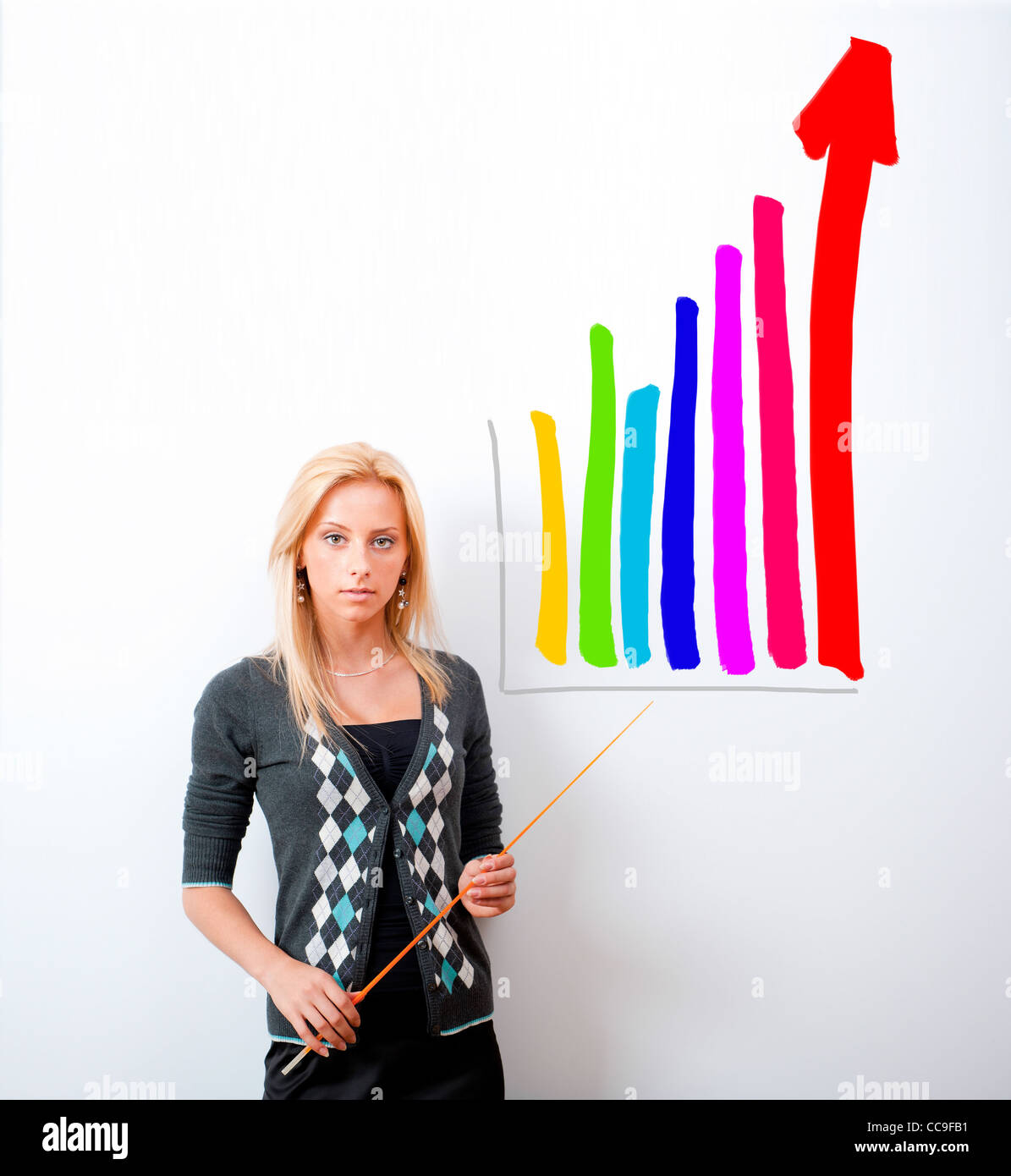 Young business teacher showing growing profit with graph on white board ...