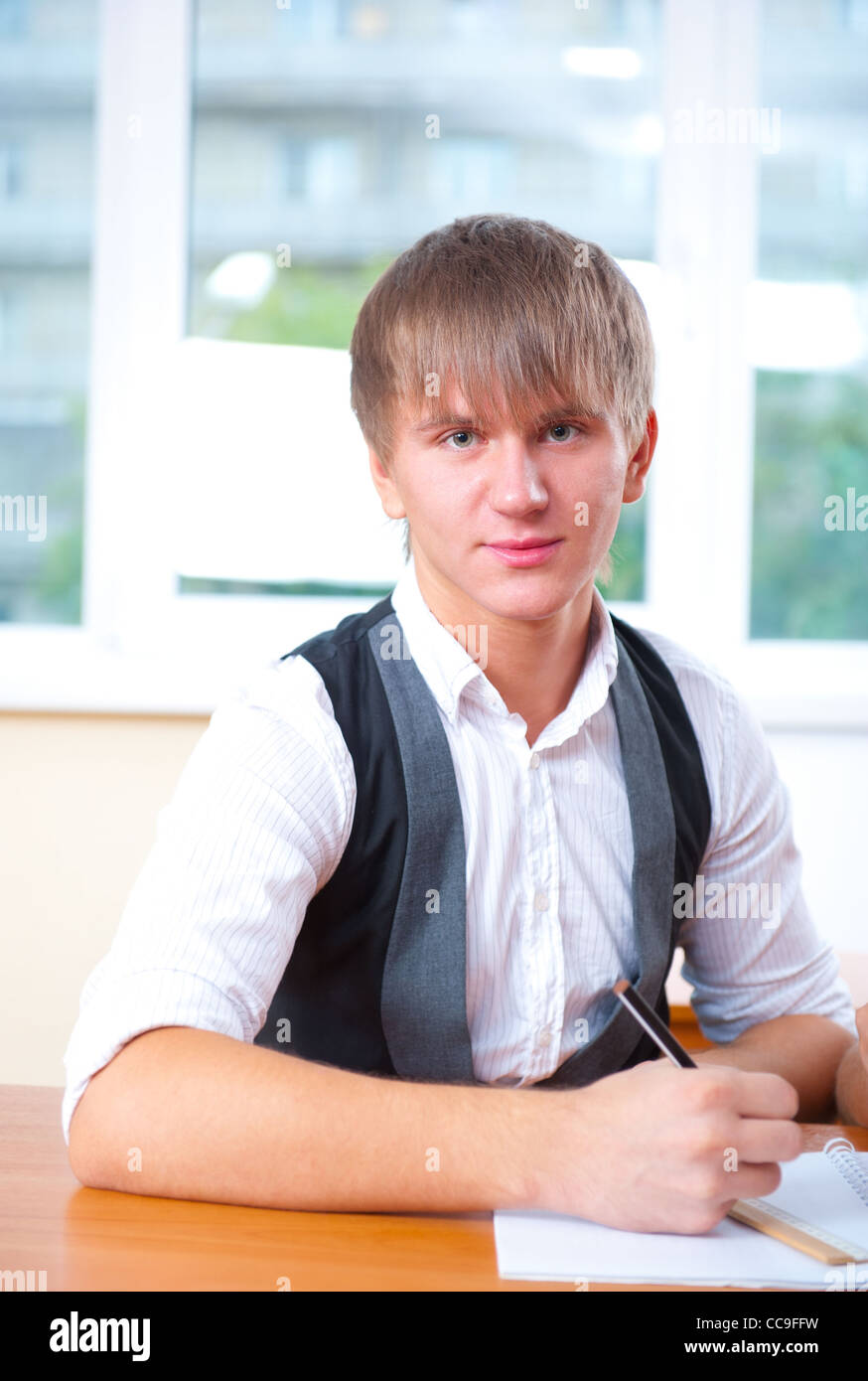Portrait of young male university student studying in classroom Stock ... Portrait of young male university student studying in classroom Stock ...