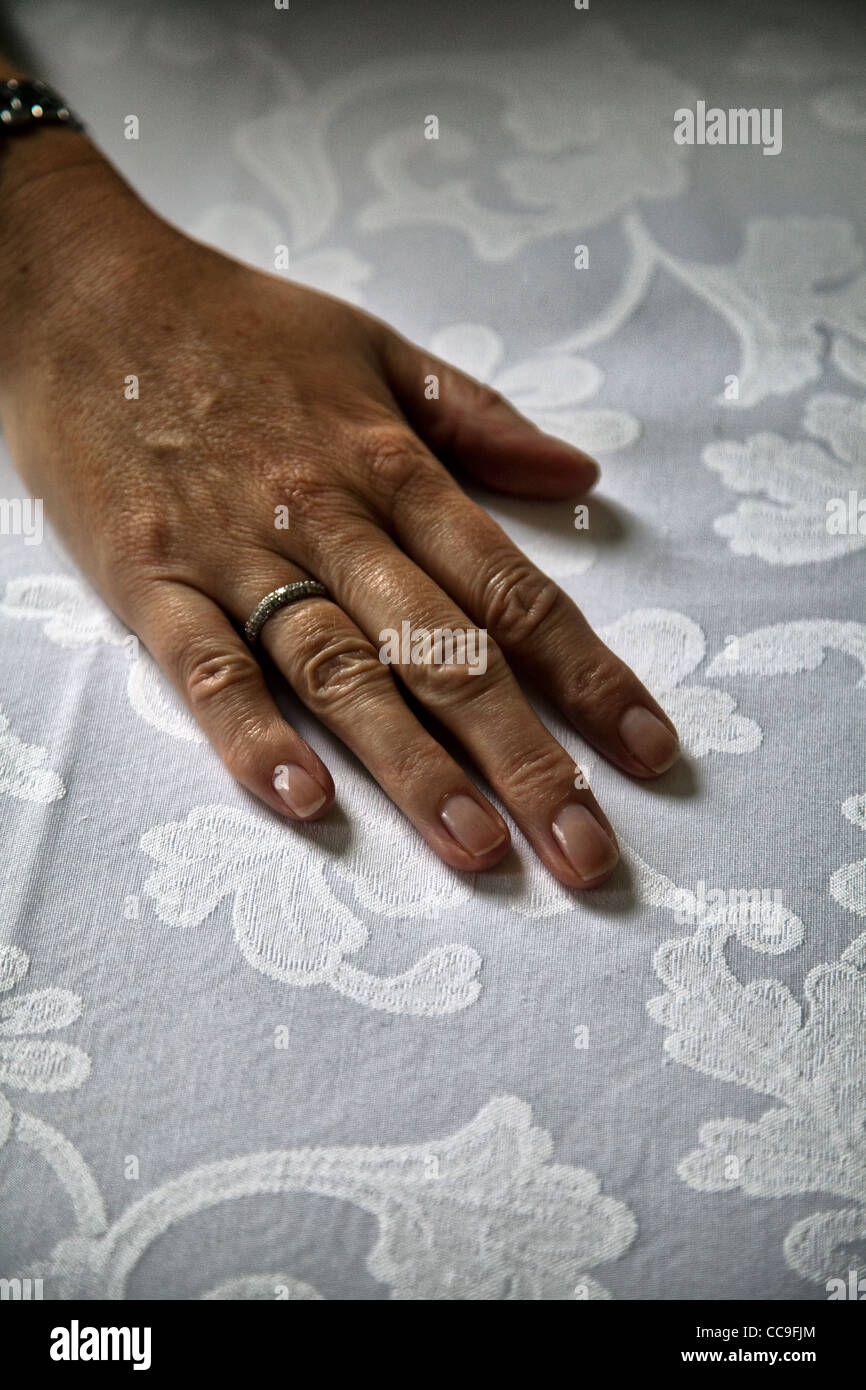 Hand with ring Resting on Table Stock Photo - Alamy