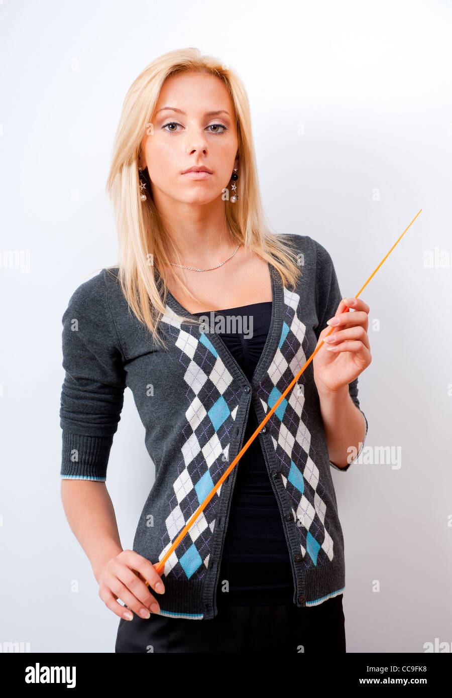 Portrait of young teacher pointing on white marker board in modern ...