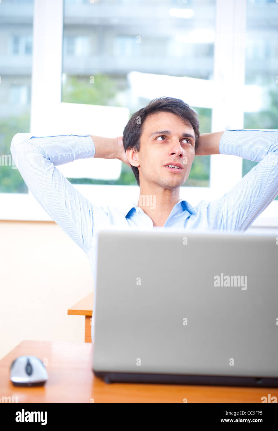A young man sitting in front of a laptop at college library Stock Photo ...