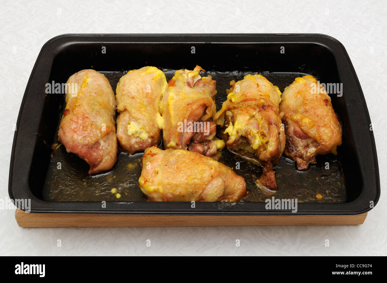 Six hot fried chicken legs on black tray on the table surface Stock ...