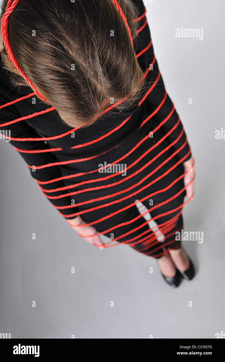 Tied - young woman in ropes Stock Photo - Alamy