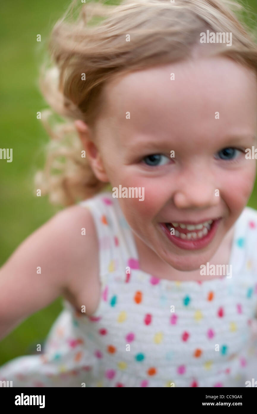 Girl running in a spotty dress Stock Photo - Alamy