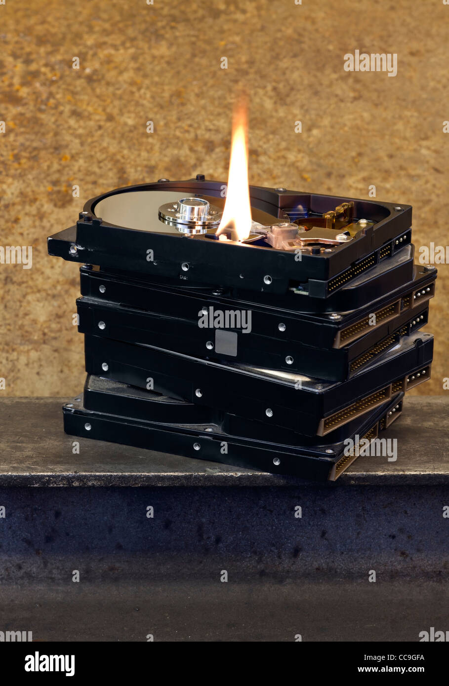 burning stack of hard disks in front of rusty back Stock Photo - Alamy