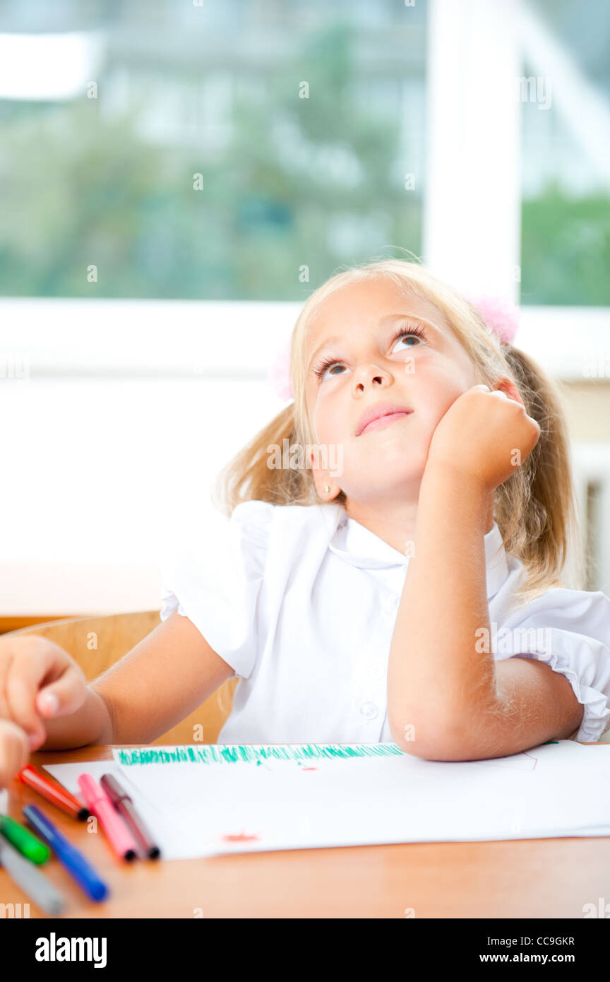 Little girl looking for a drawing concept wile painting picture on ...