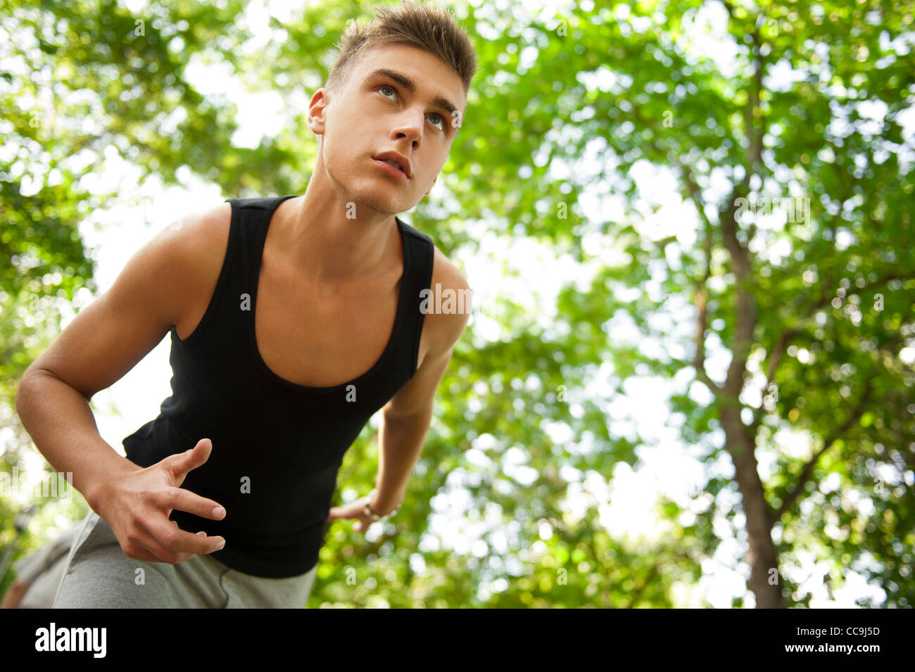 Closeup Portrait of young man running in park. Horizontal shot Stock ...