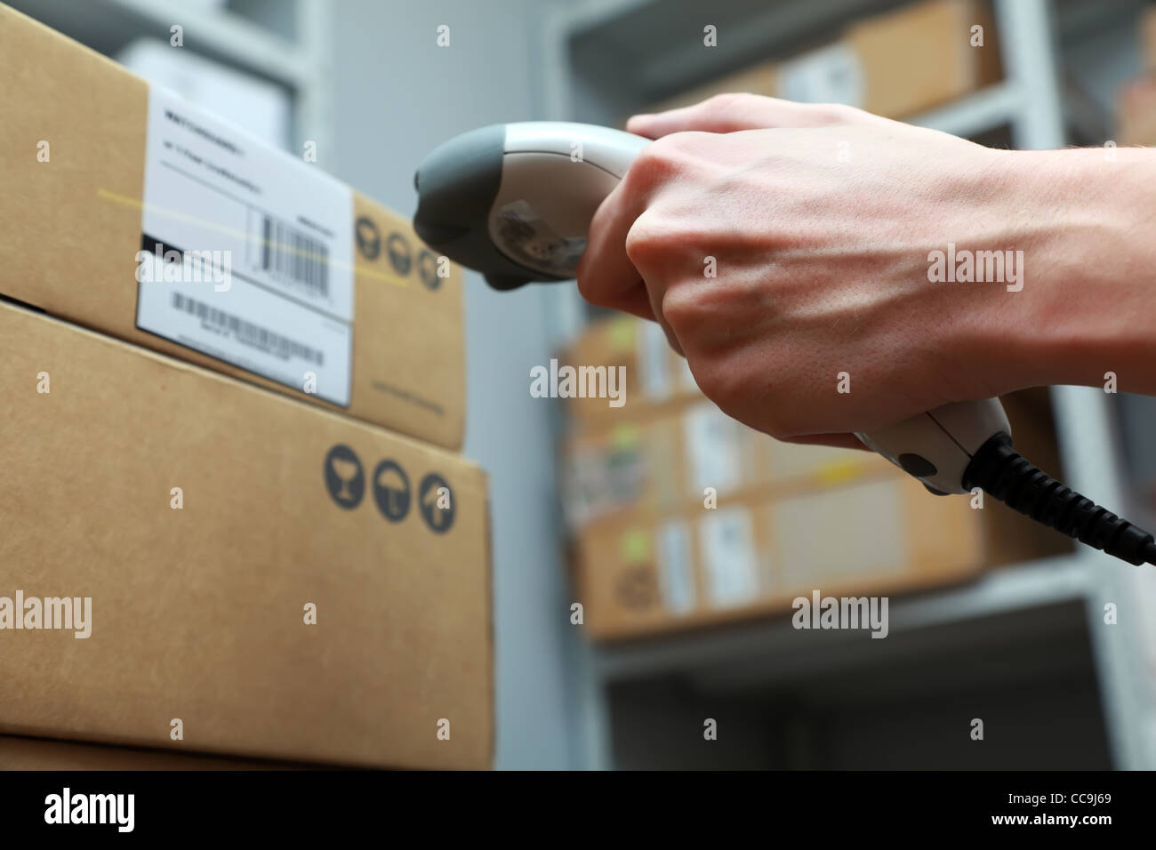 Warehouse works. Man hand hold barcode scanner Stock Photo - Alamy