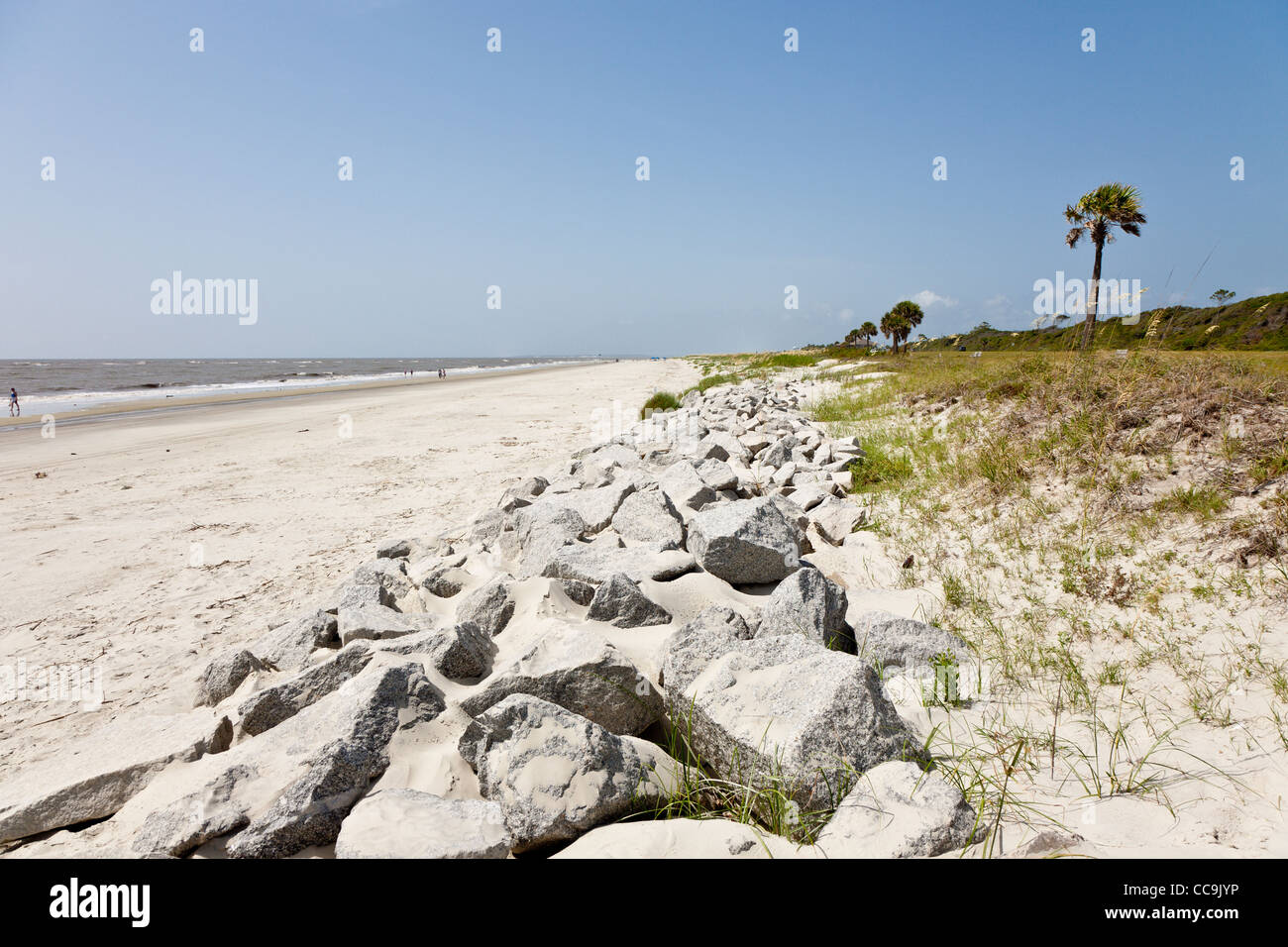 Large granite boulders act as a seawall on the wide public sand beach ...